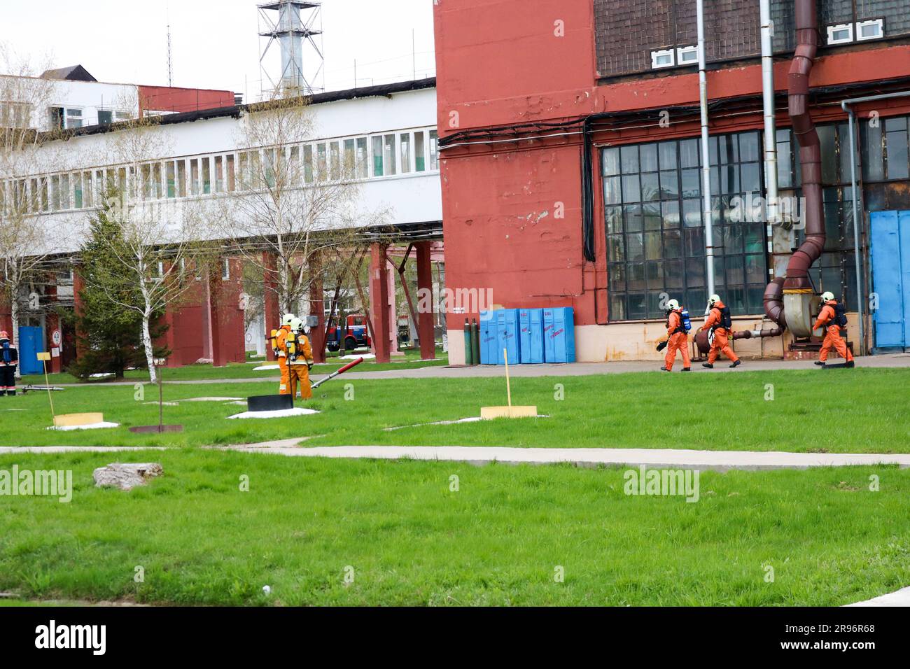 Professional firefighters, rescuers in protective fireproof suits ...