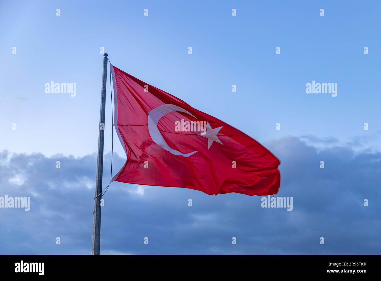 A picture of the Turkish flag against a blue sky at sunset Stock Photo ...