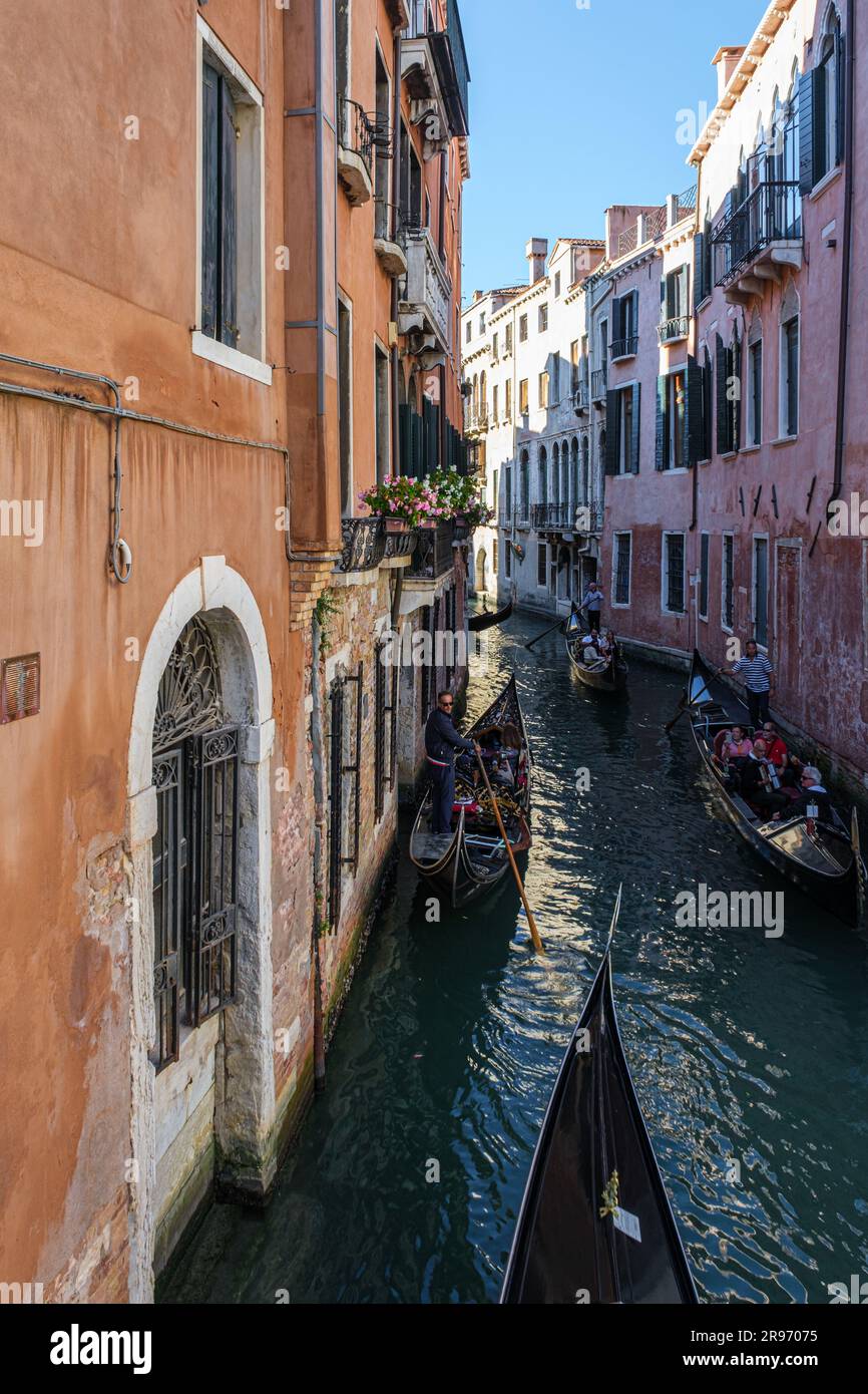 An Italian canal, showing the narrow waterways and gondolas bobbing in ...