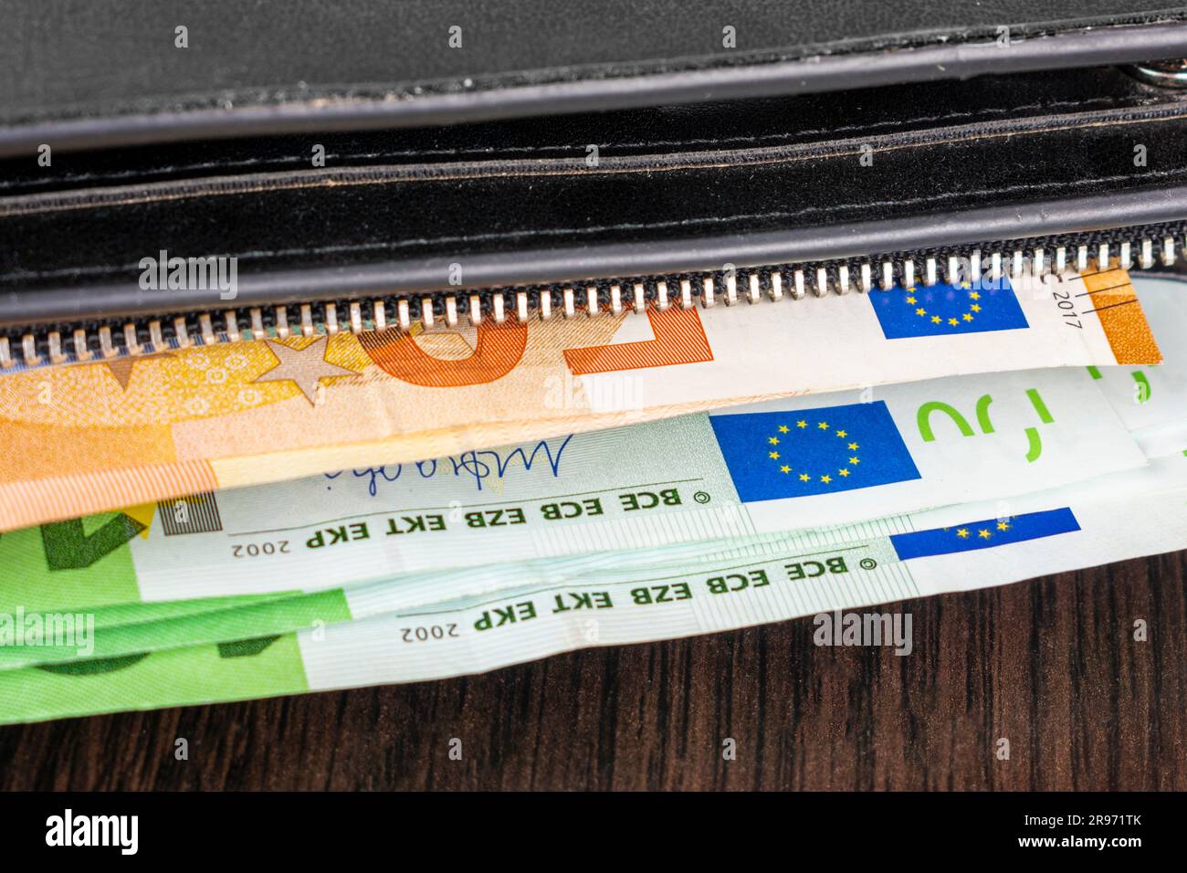 Open purse with euro cash denominations of denomination 10 20 50 100 on ...