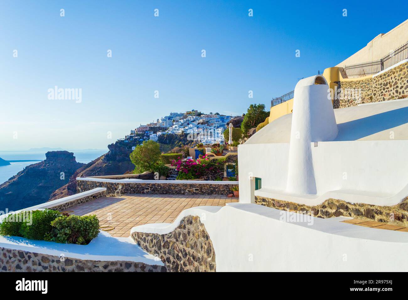 Cliff top terraces of luxury hotels with amazing sea views in Santorini ...