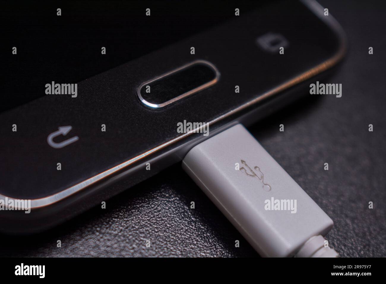 black smartphone on a black matte background with a white connected ...