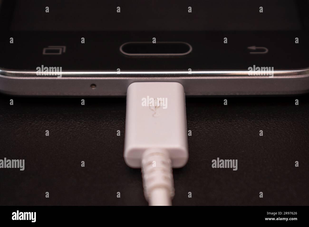 black smartphone on a black matte background with a white connected ...