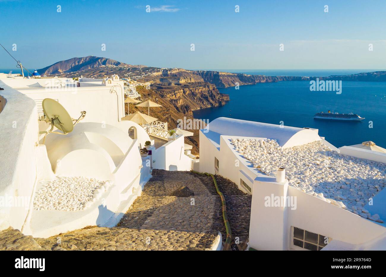 Cliff top terraces of luxury hotels with amazing sea views in Santorini ...