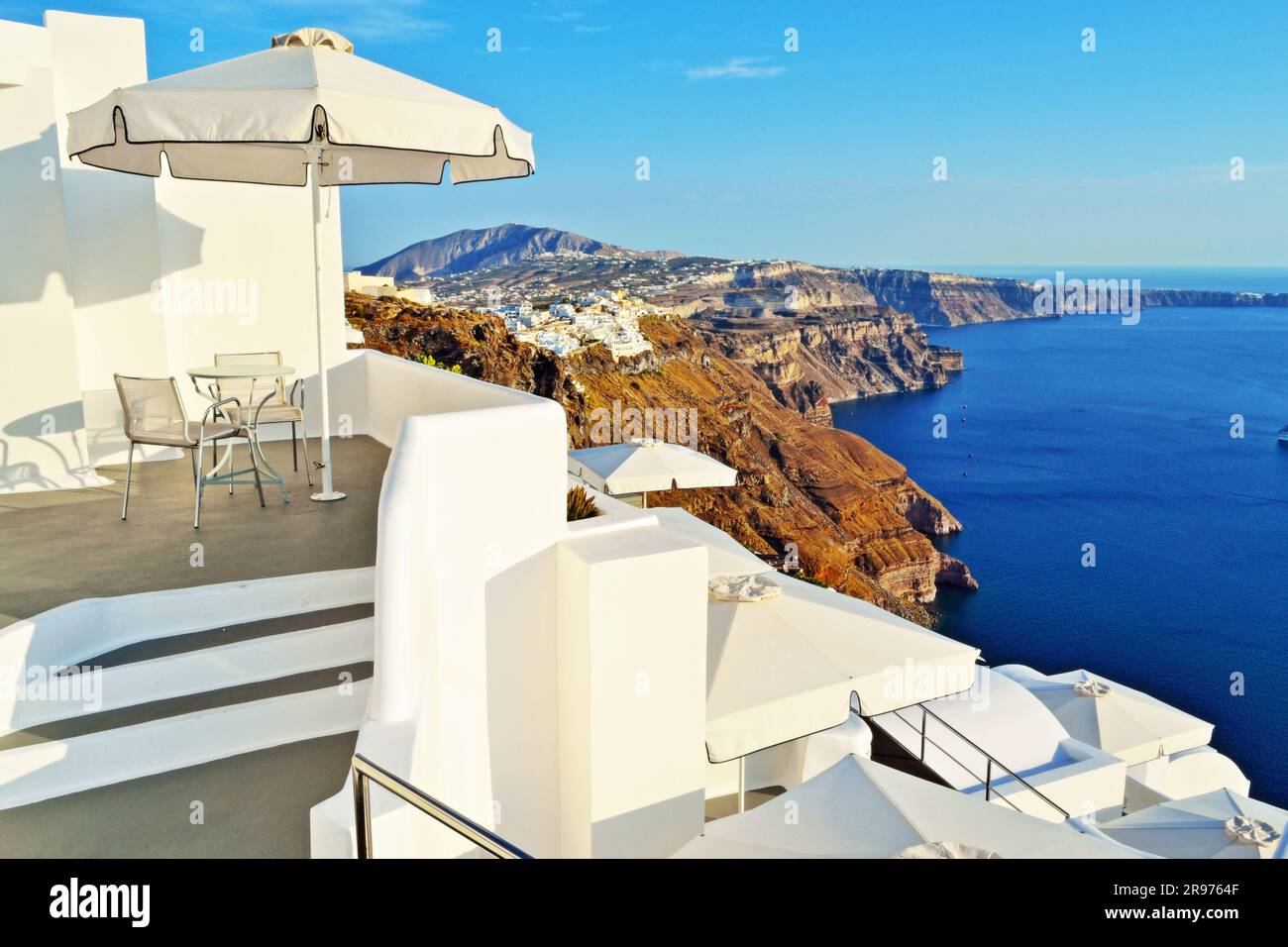 Cliff top terraces of luxury hotels with amazing sea views in Santorini ...
