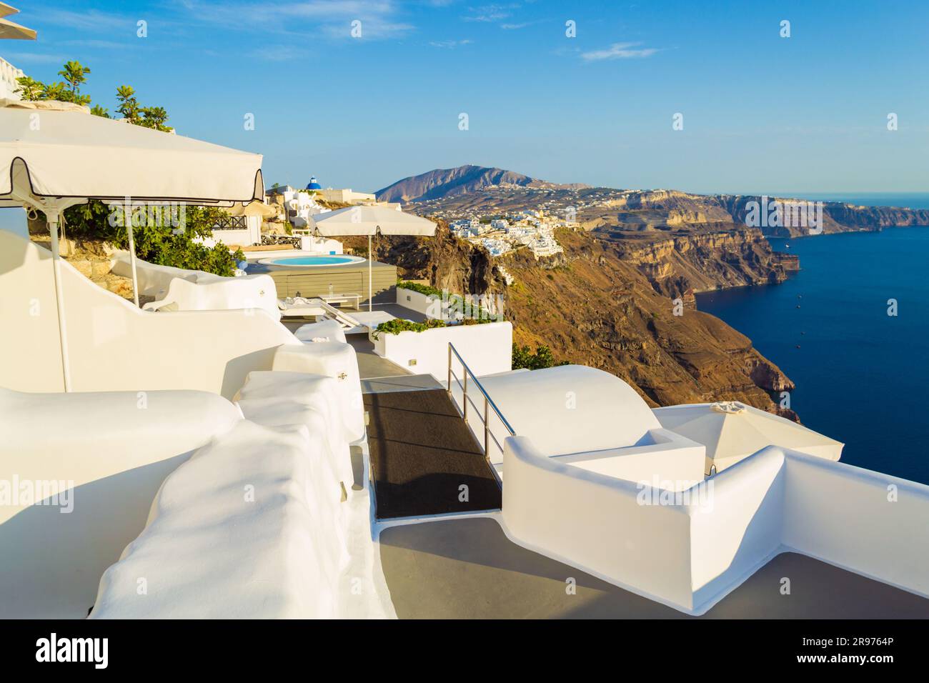 Cliff top terraces of luxury hotels with amazing sea views in Santorini ...