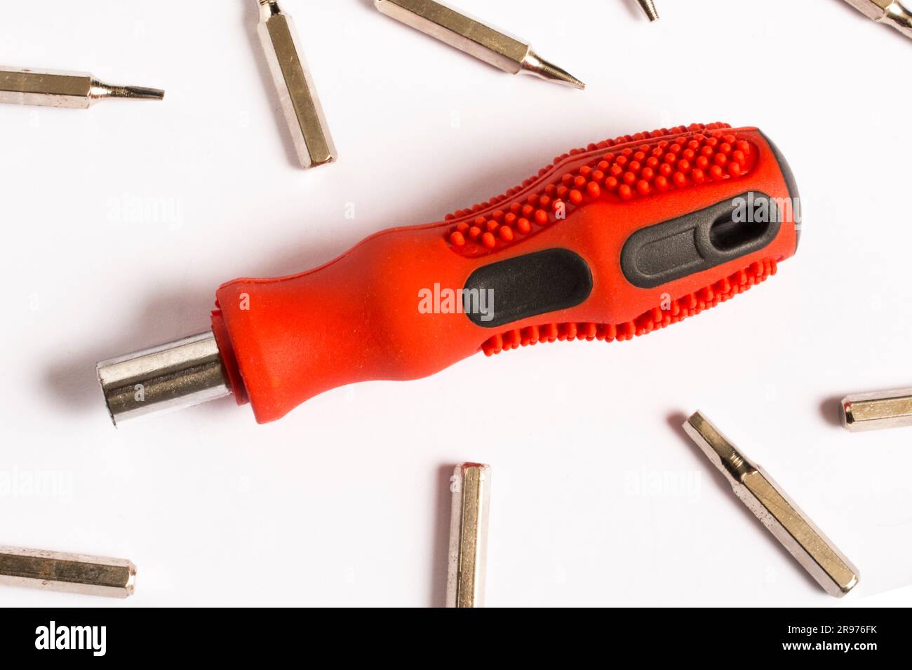 red screwdriver, white background and bits, spare parts Stock Photo - Alamy