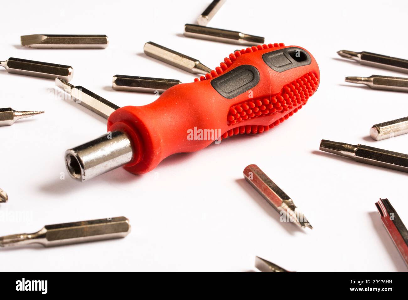 red screwdriver, white background and bits, spare parts Stock Photo - Alamy