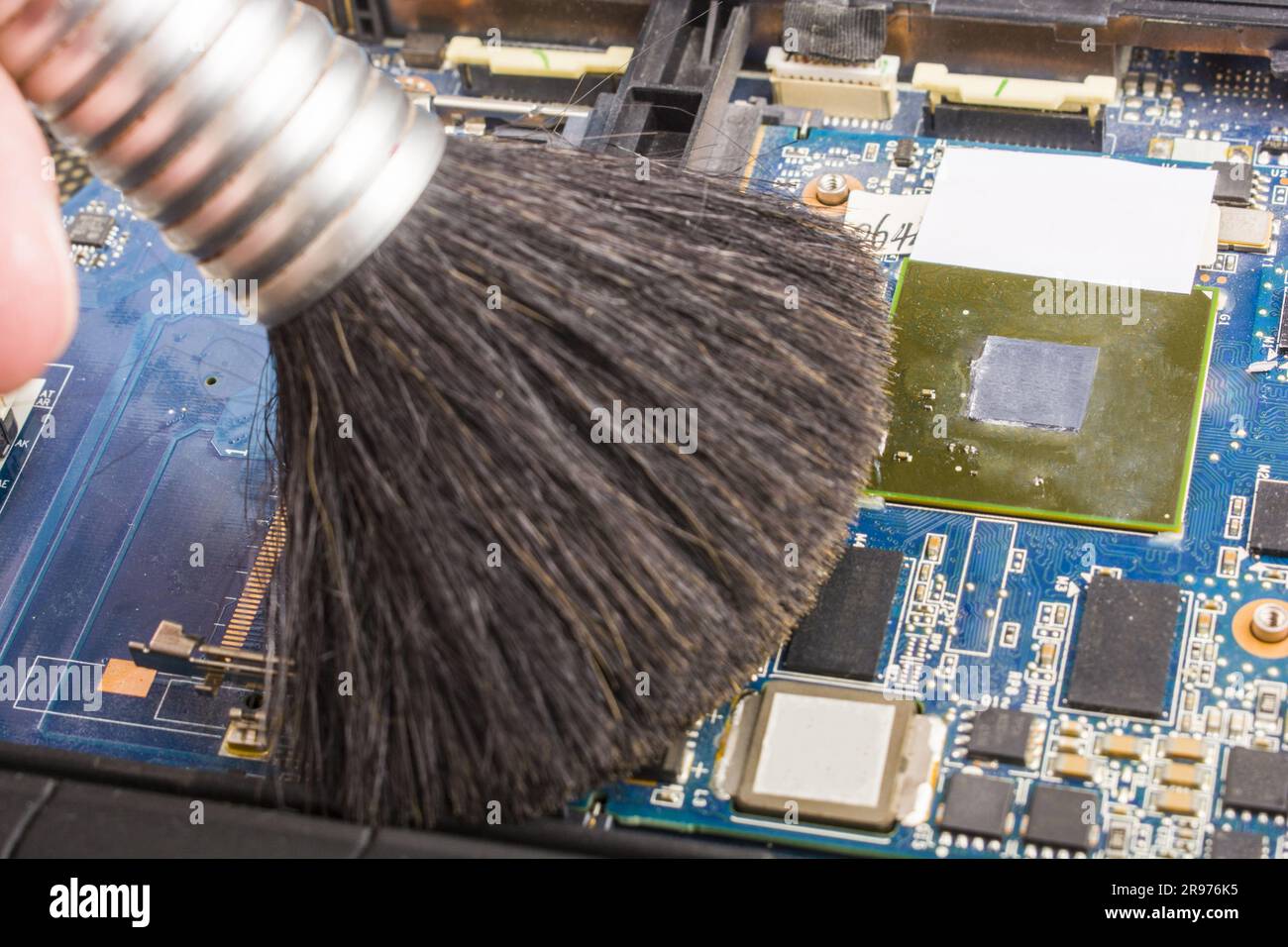 Cleaning the motherboard from dust and debris with a brush Stock Photo ...