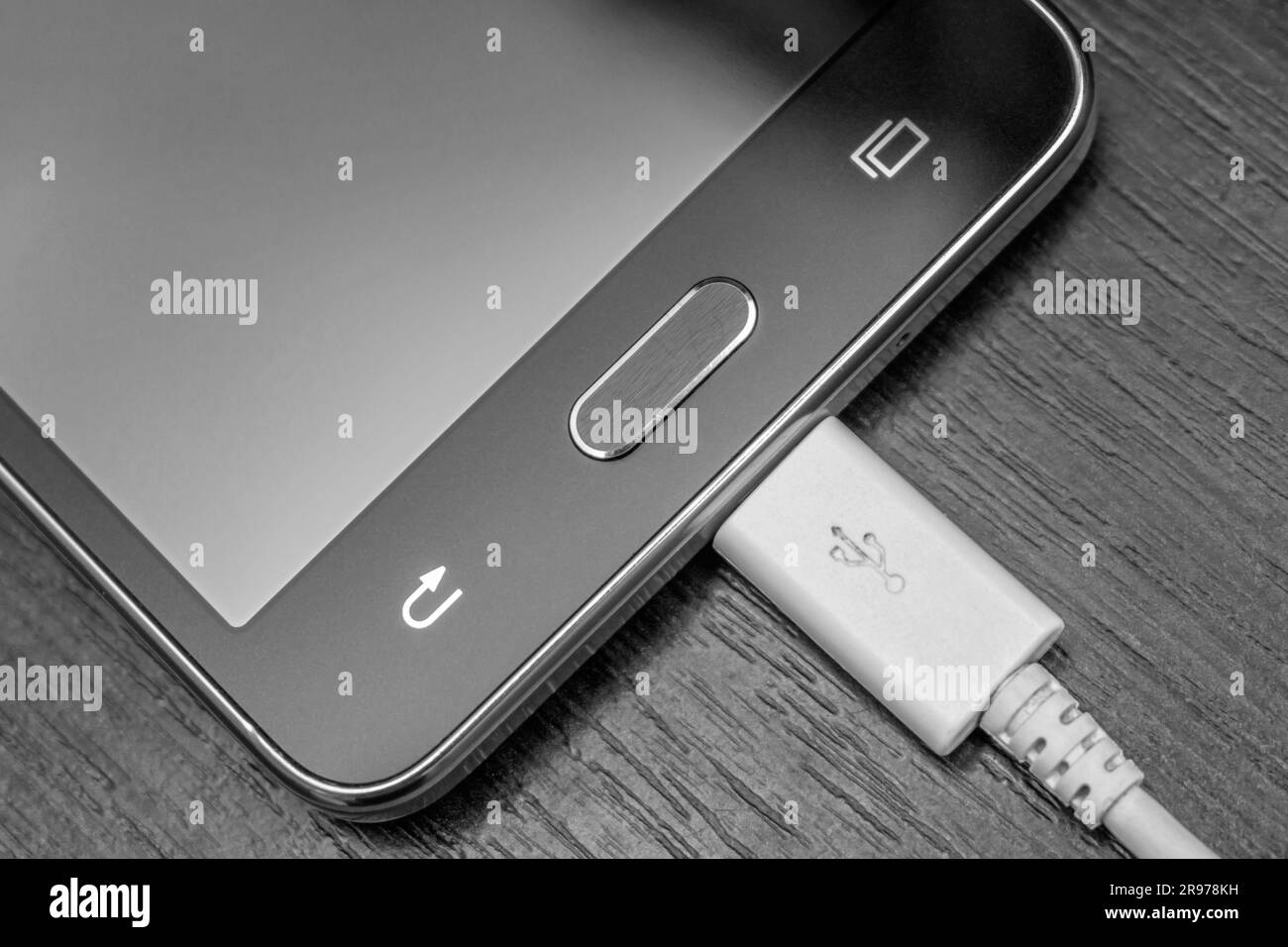 Phone photos are charged with a white wire on a gray background Stock ...