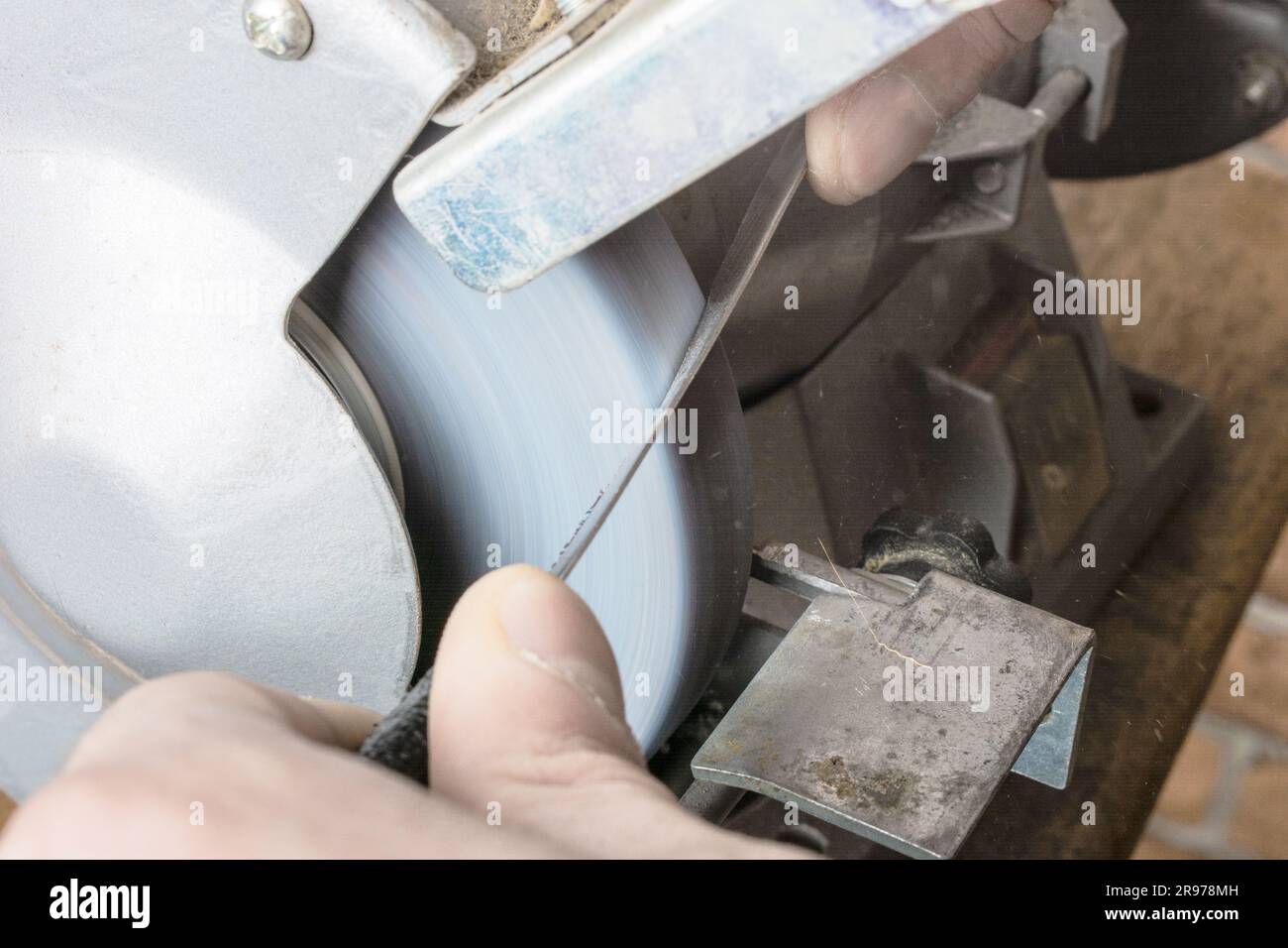 Knife sharpener in the form of a circle and a hand with a blade on the ...