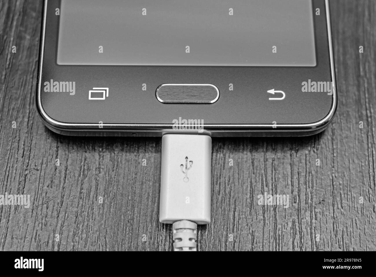 Phone photos are charged with a white wire on a gray background Stock ...