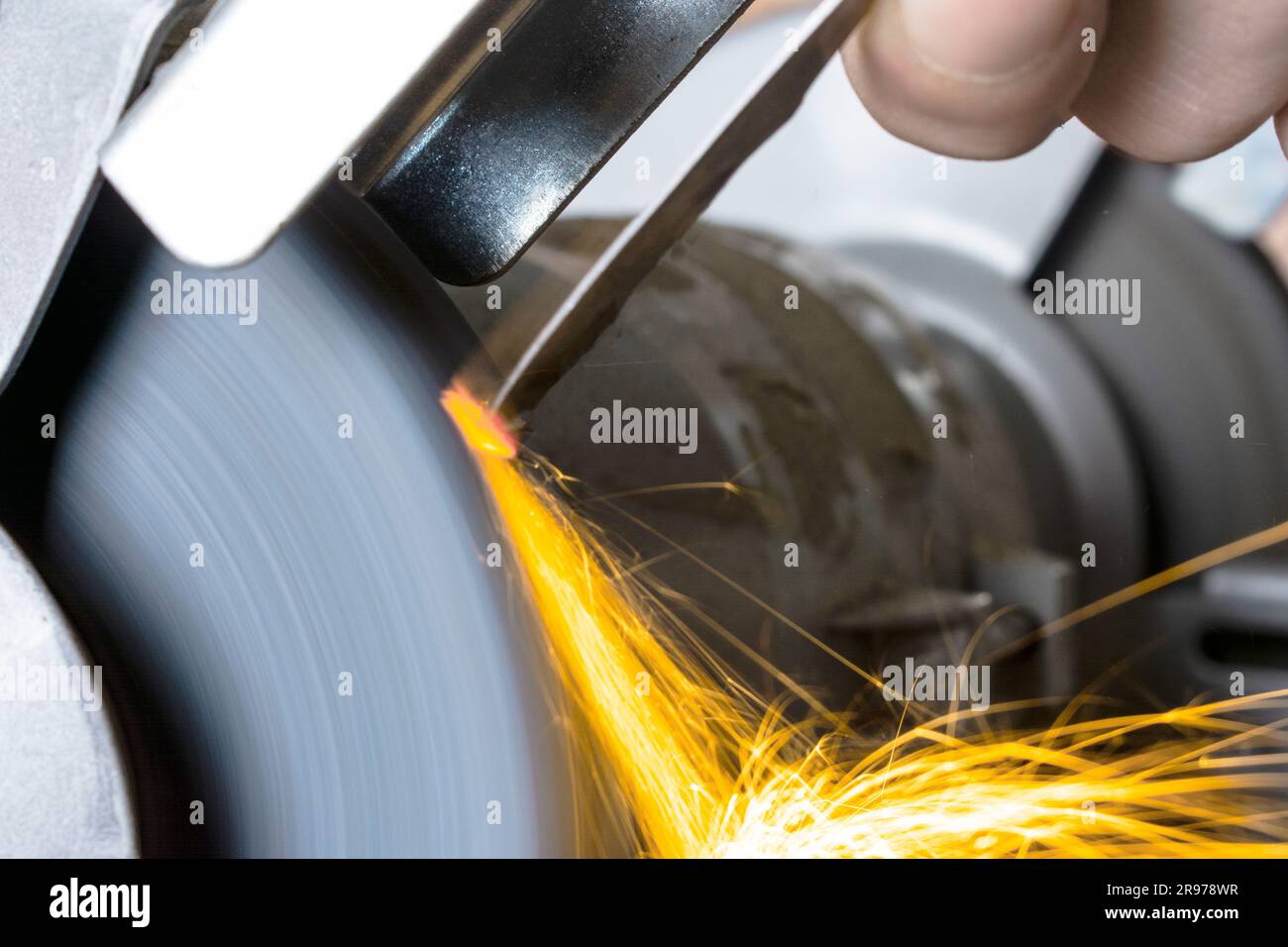 Knife sharpener in the form of a circle and a hand with a blade on the ...