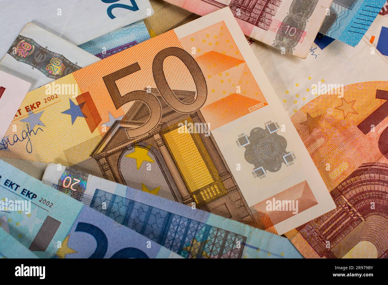 a small pile of paper euro bills as part of the trading system Stock ...