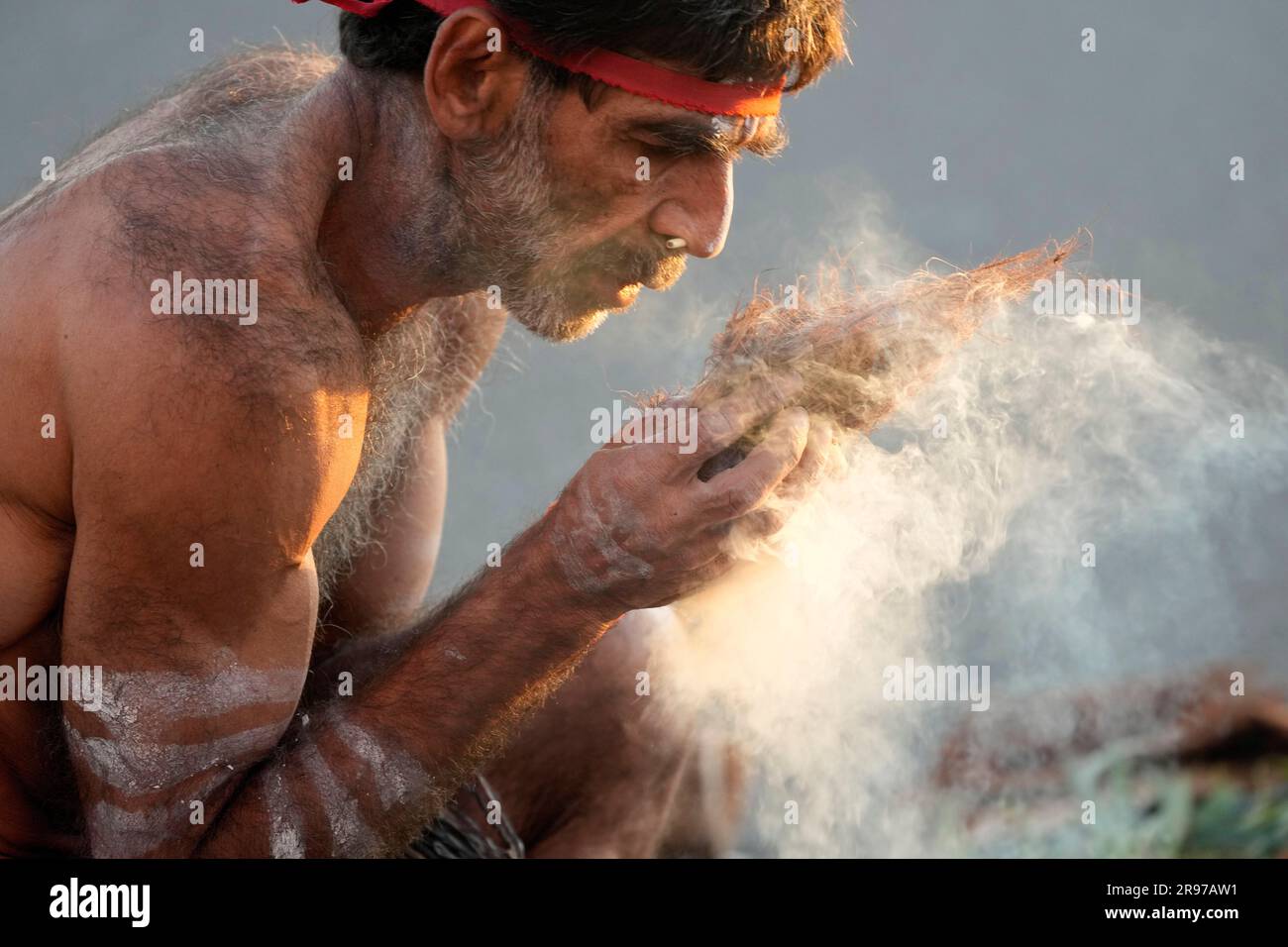 Aboriginal man Uncle Les McLeod starts a fire for a traditional smoking ...