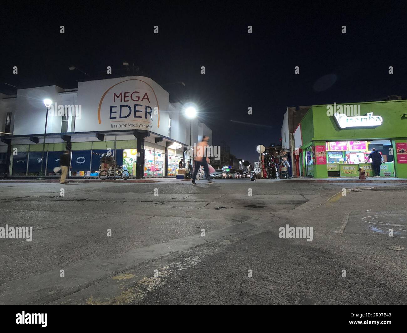 Daily life in the center of the city at dusk with people walking in ...