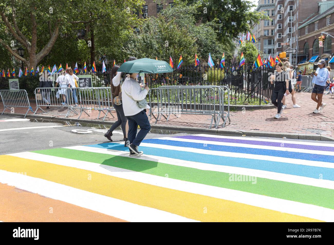 A crosswalk is decorated in rainbow colors in honor of LGBTQIA pride ...