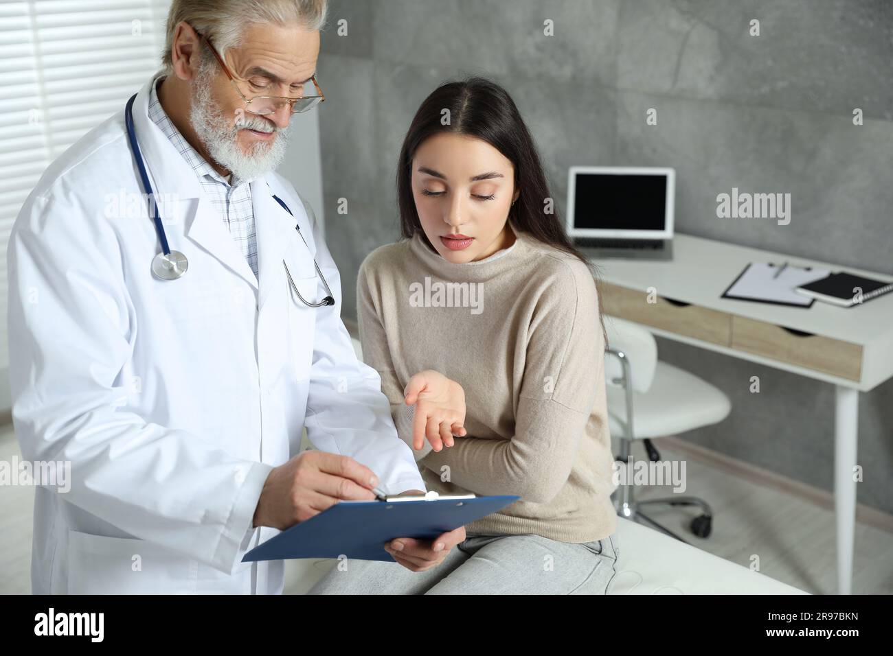 Patient having appointment with senior doctor in clinic Stock Photo - Alamy