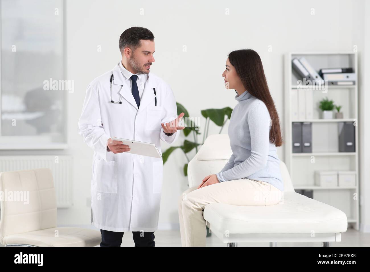Patient having appointment with doctor in clinic Stock Photo - Alamy