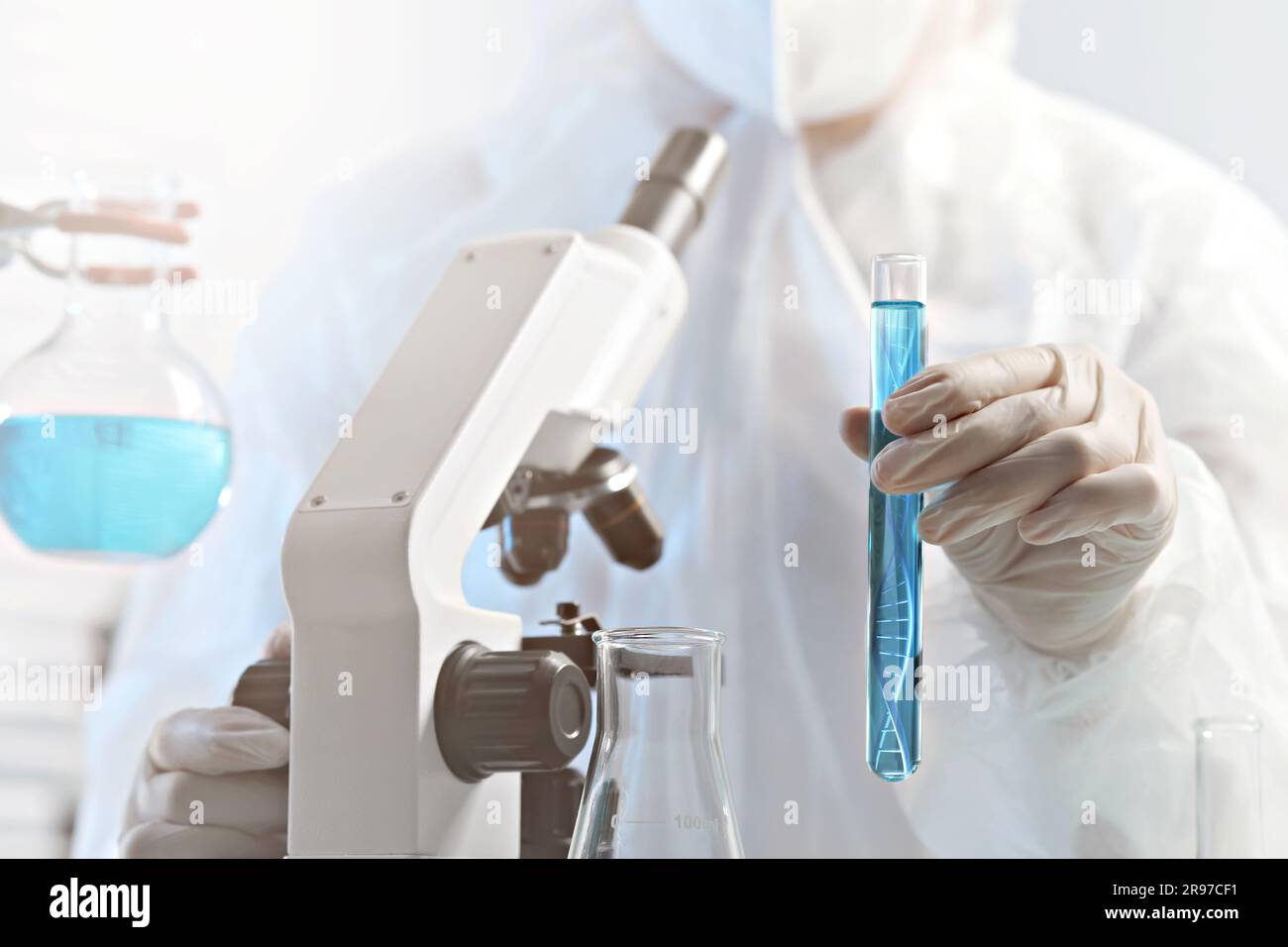 Genetics research. Scientist holding test tube with liquid and ...