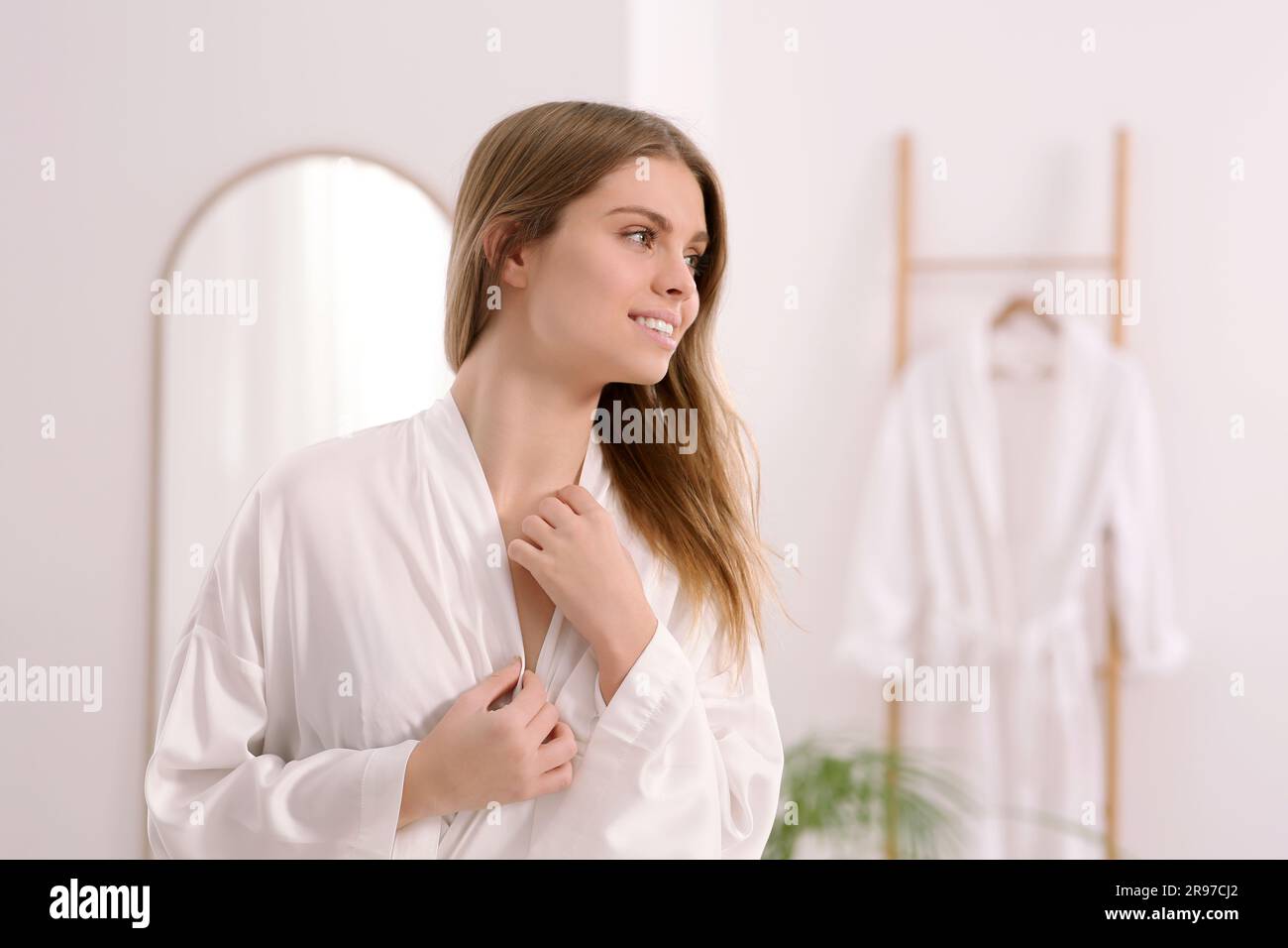 Woman wearing white bath robe hi-res stock photography and images - Alamy