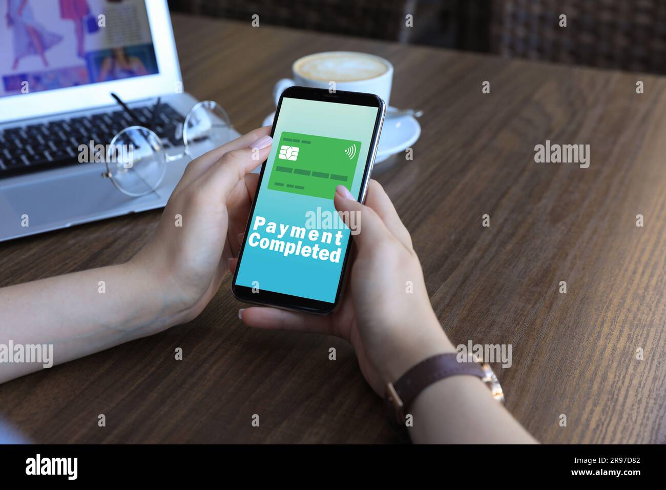 Woman successfully made payment using online banking application on smartphone at table, closeup ...