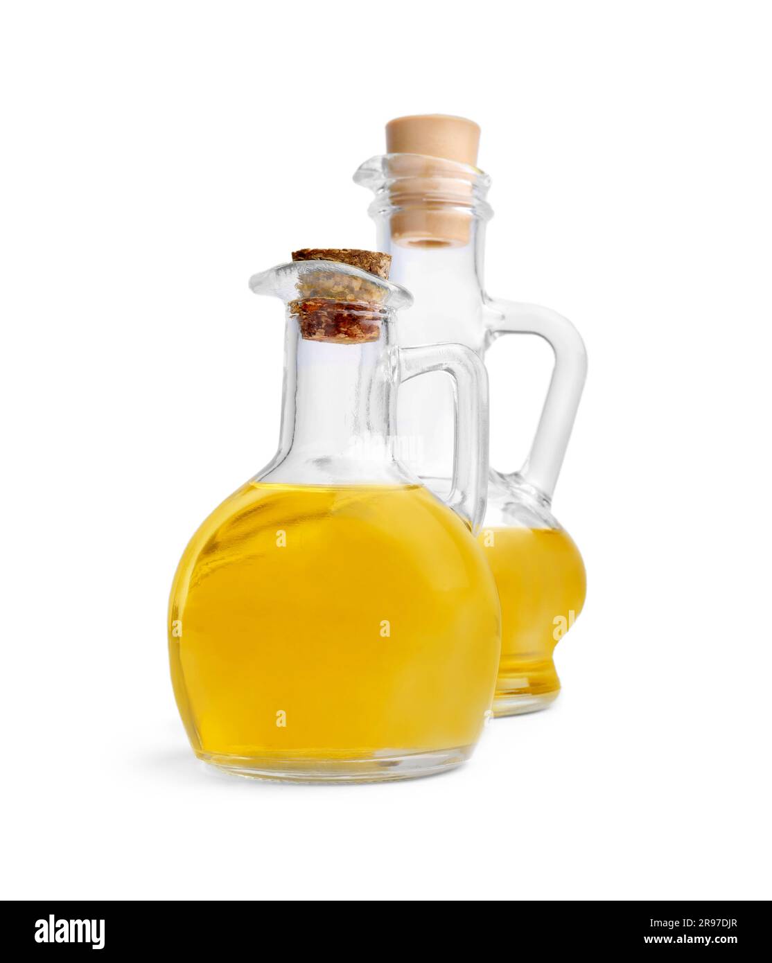 Glass jugs of cooking oil on white background Stock Photo - Alamy