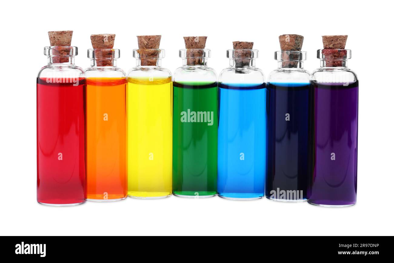 Glass bottles with different food coloring on white background Stock ...
