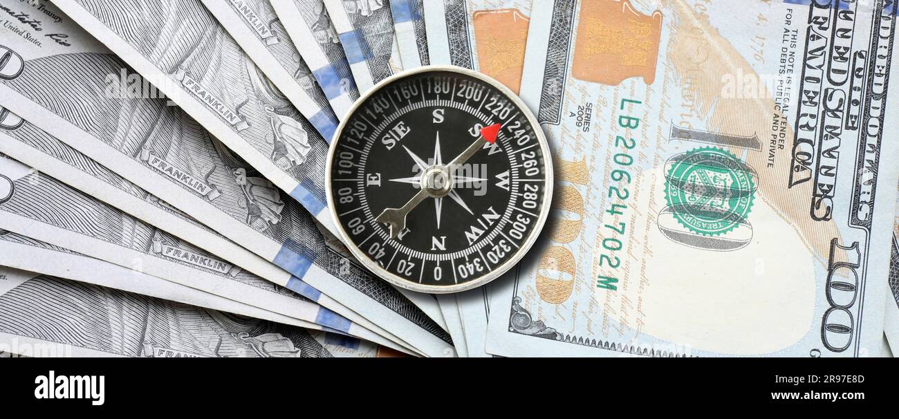 Exchange rate. Money (dollar banknotes) and compass as background, top ...