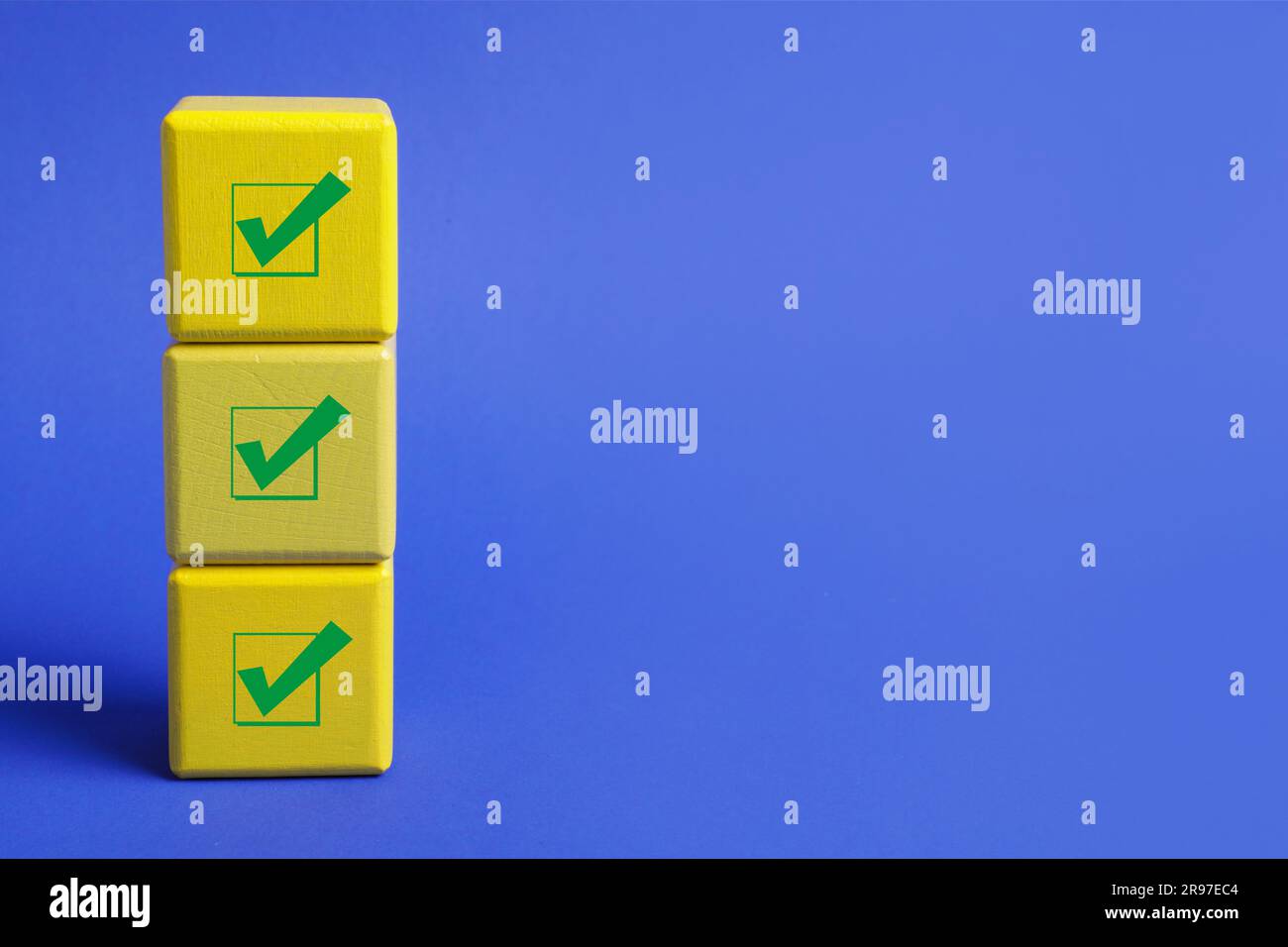 Stacked cubes with check marks on blue background. Space for text Stock ...