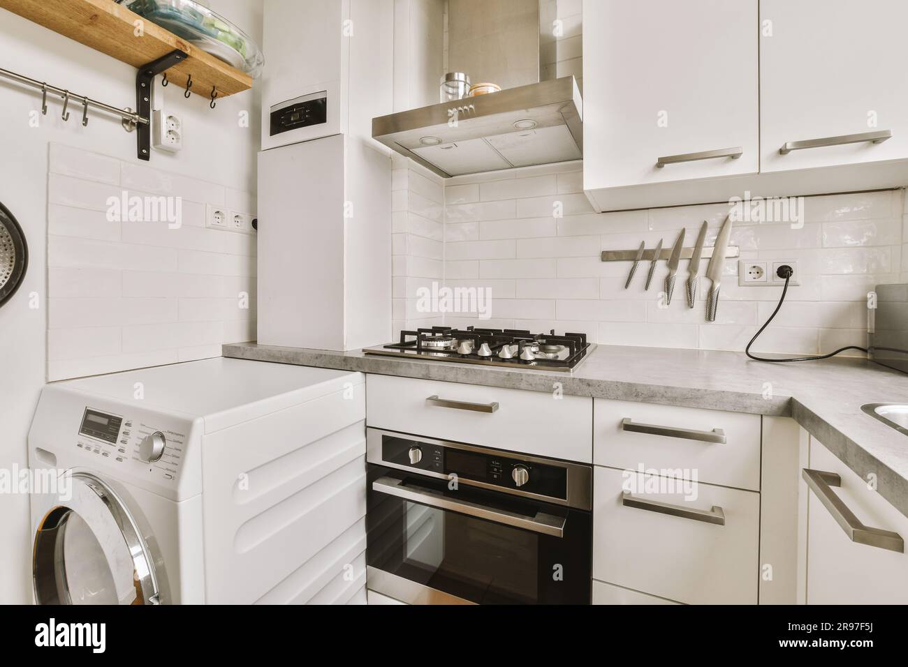 a small kitchen with a washer and dryer on the counter in front of the ...