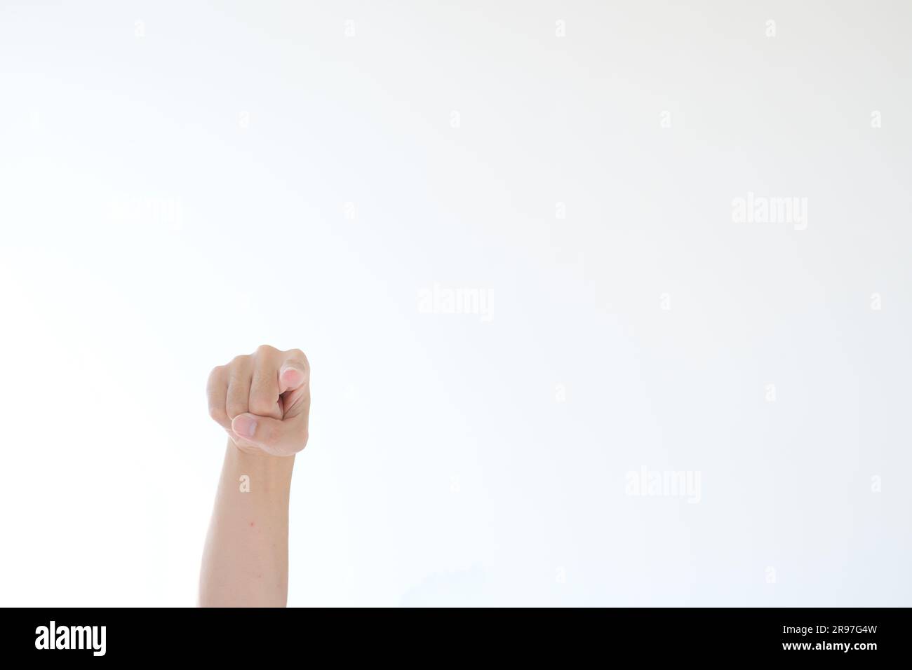 A hand is pointing to the camera. Isolated white background. Minimalist ...