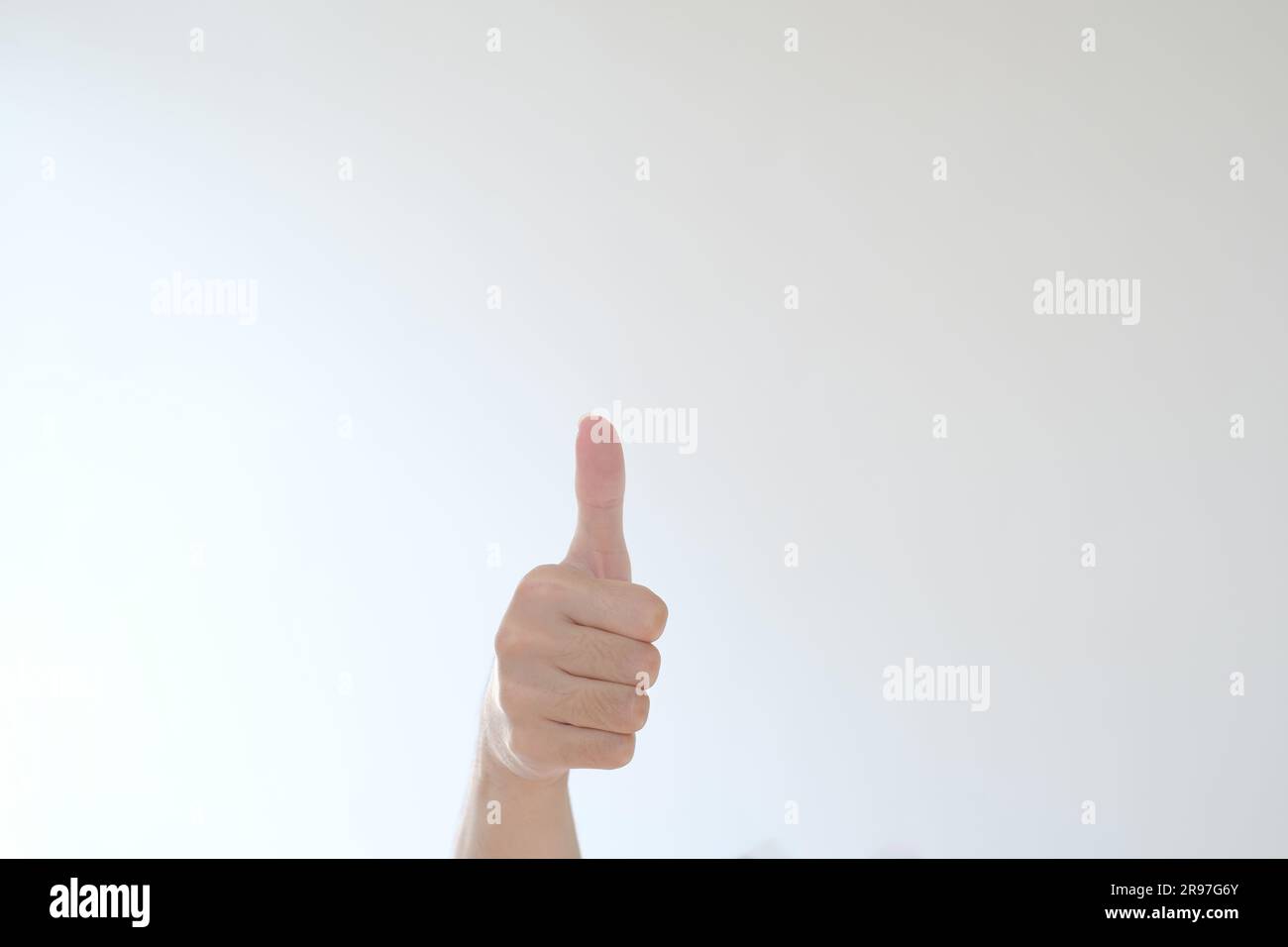 A thumb up hand on isolated white background Stock Photo - Alamy