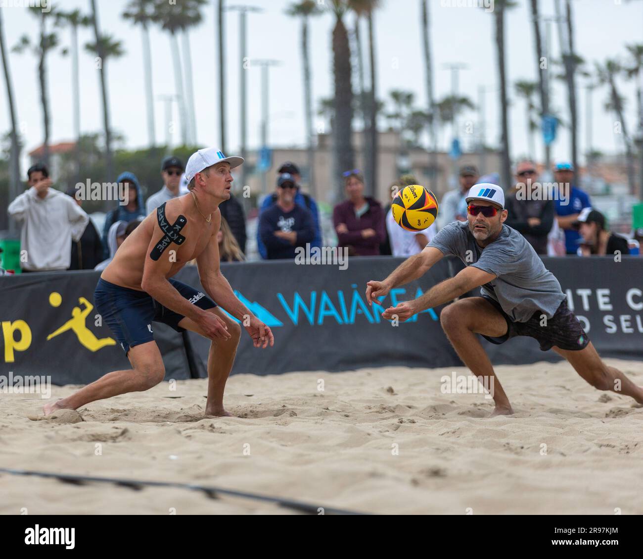 Avery Drost and Phil Dalhausser react to a serve down the middle during ...
