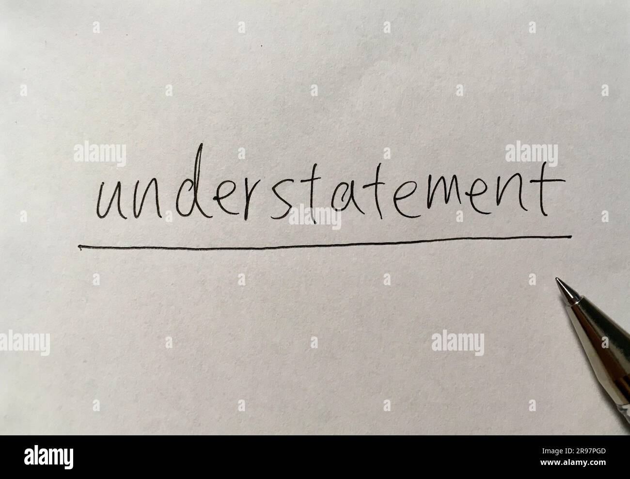 Understatement concept word on paper background Stock Photo - Alamy
