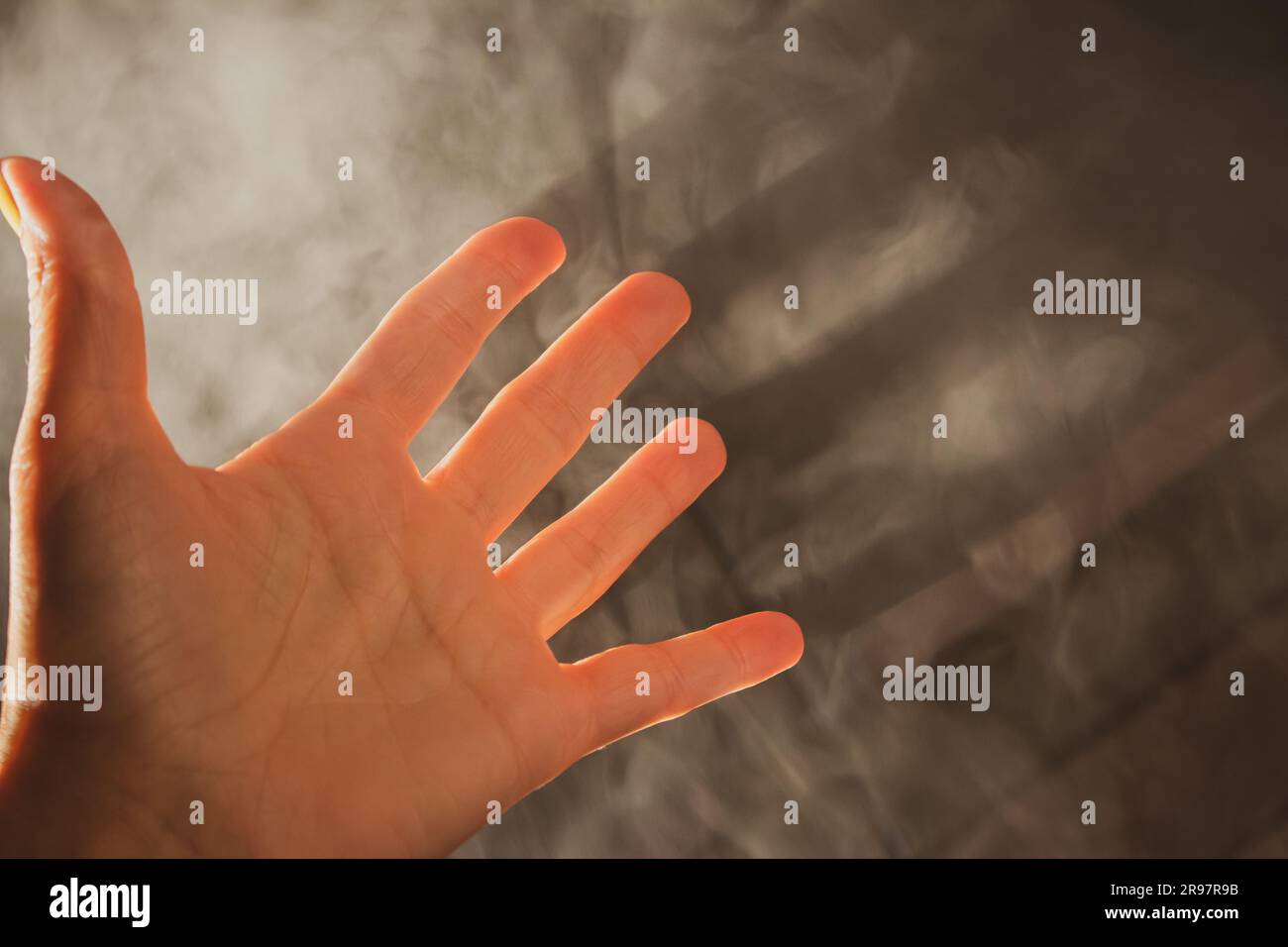 Open palm with five fingers in fume. Human arm in natural light with ...