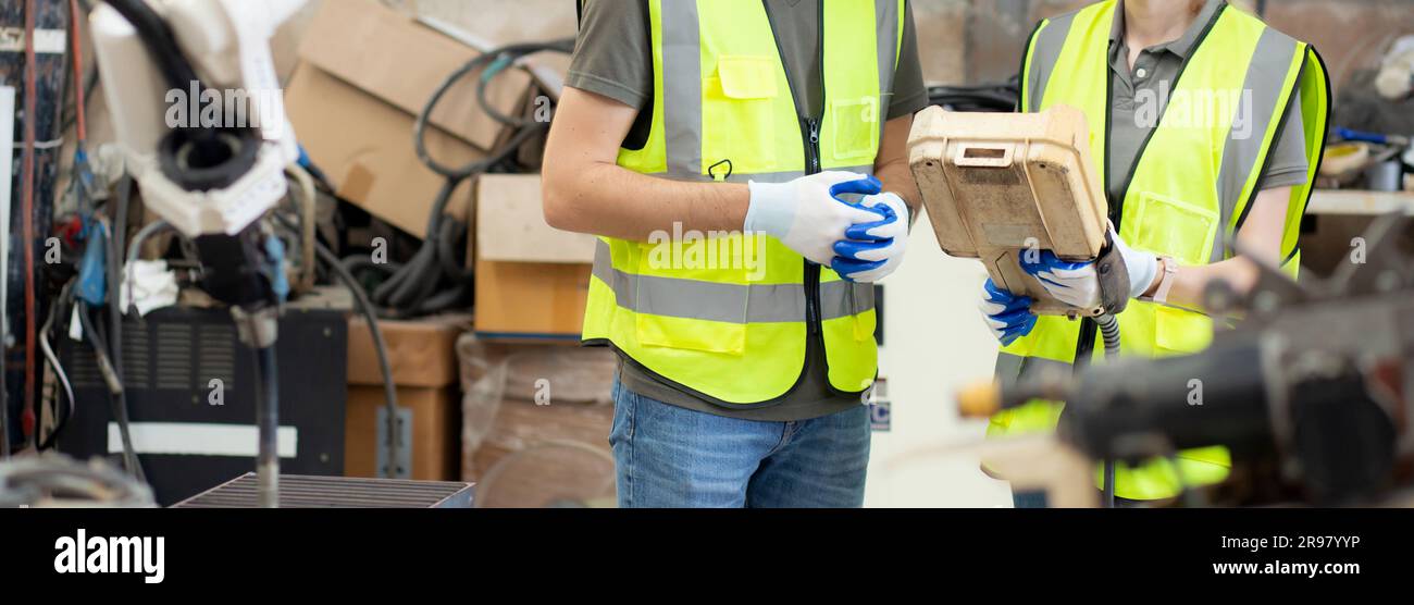 Engineer man and woman talking and explaining about robot arms ...