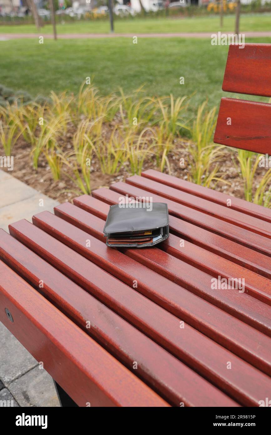left wallet on a bench in the park Stock Photo - Alamy