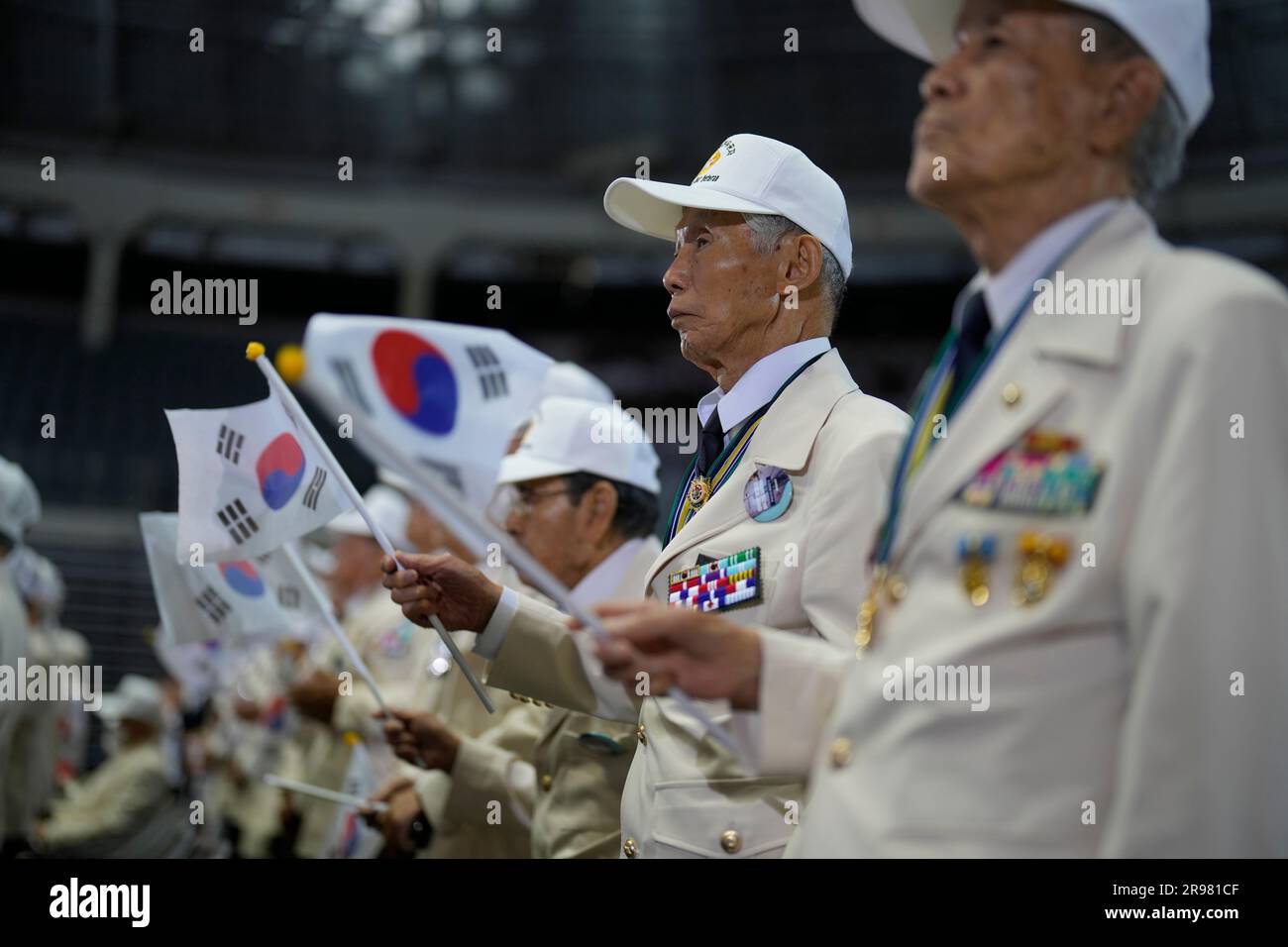 War veterans wave national flags during a ceremony marking the 73rd ...