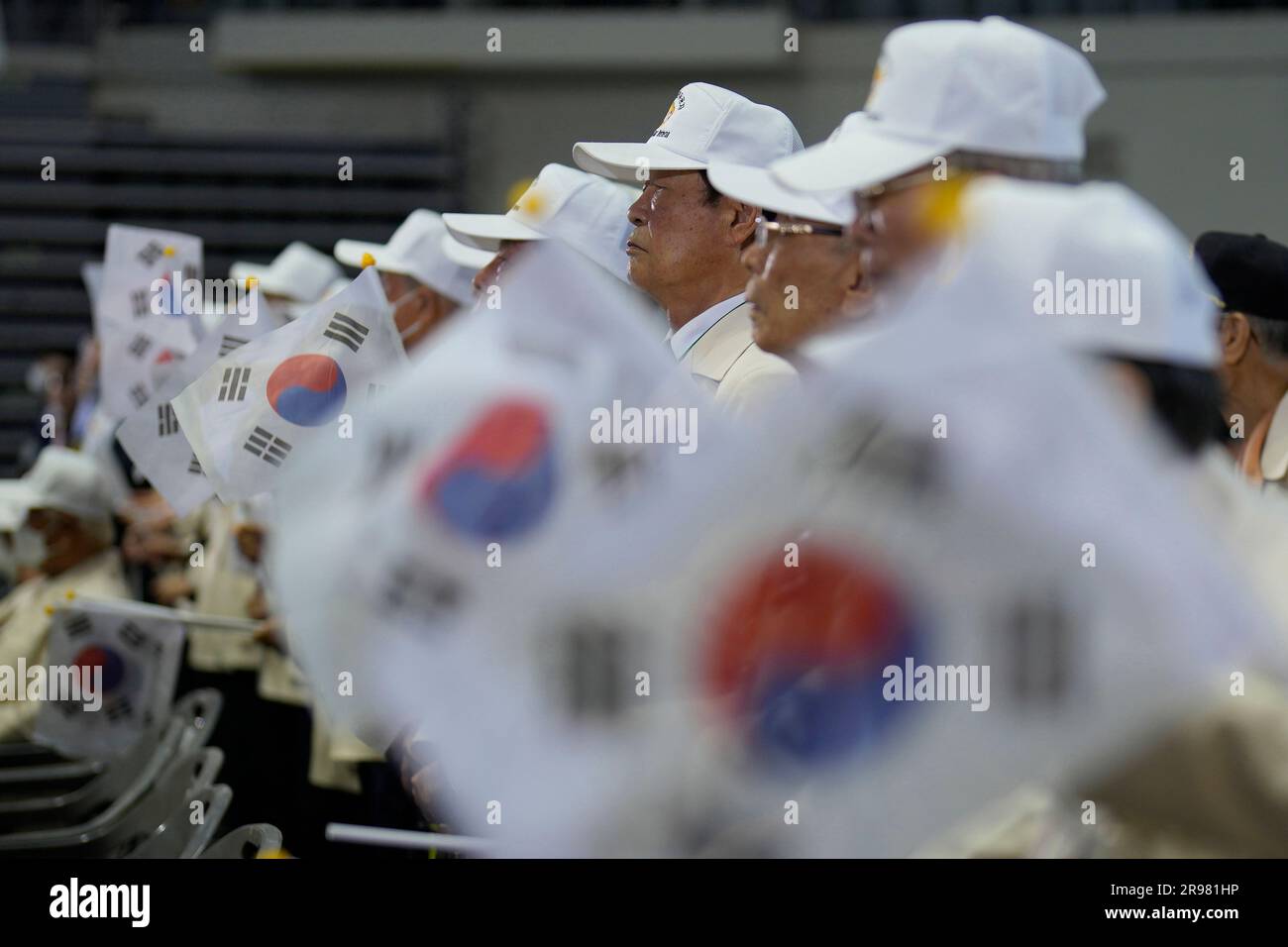 War veterans wave national flags during a ceremony marking the 73rd ...