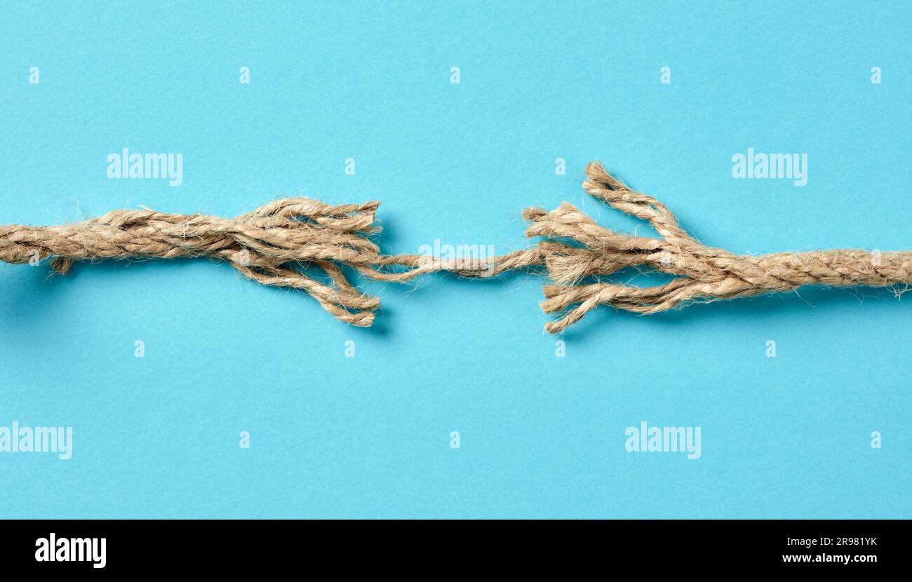 Tension, separation, danger or risk concepts. Frayed rope is about to ...