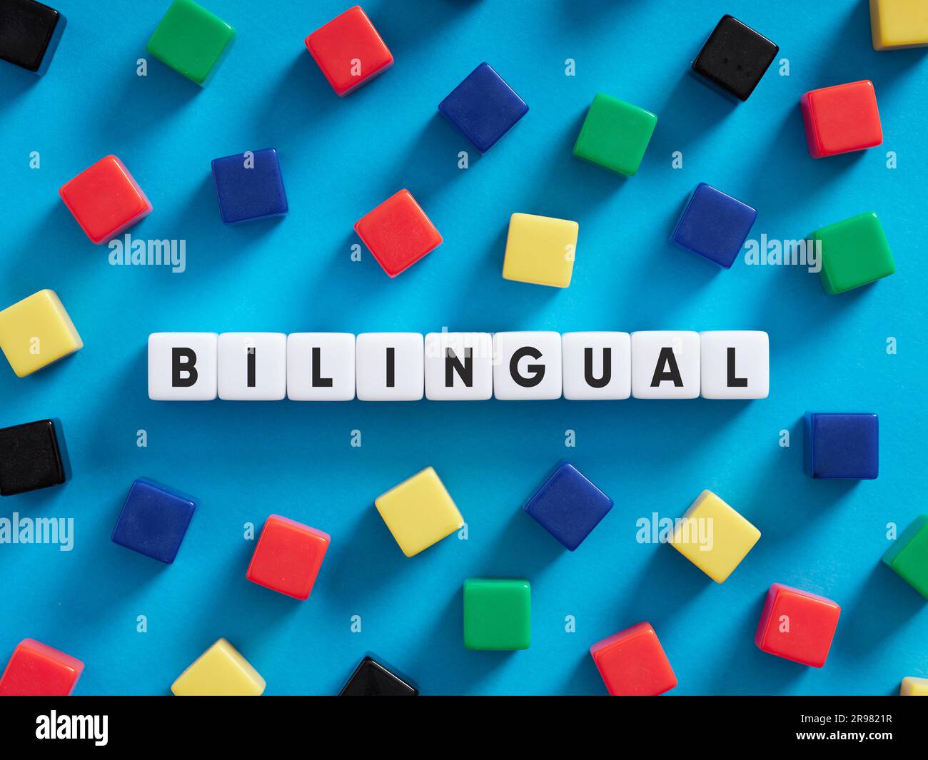 Bilingual education concept. Colorful cubes on blue background with the ...