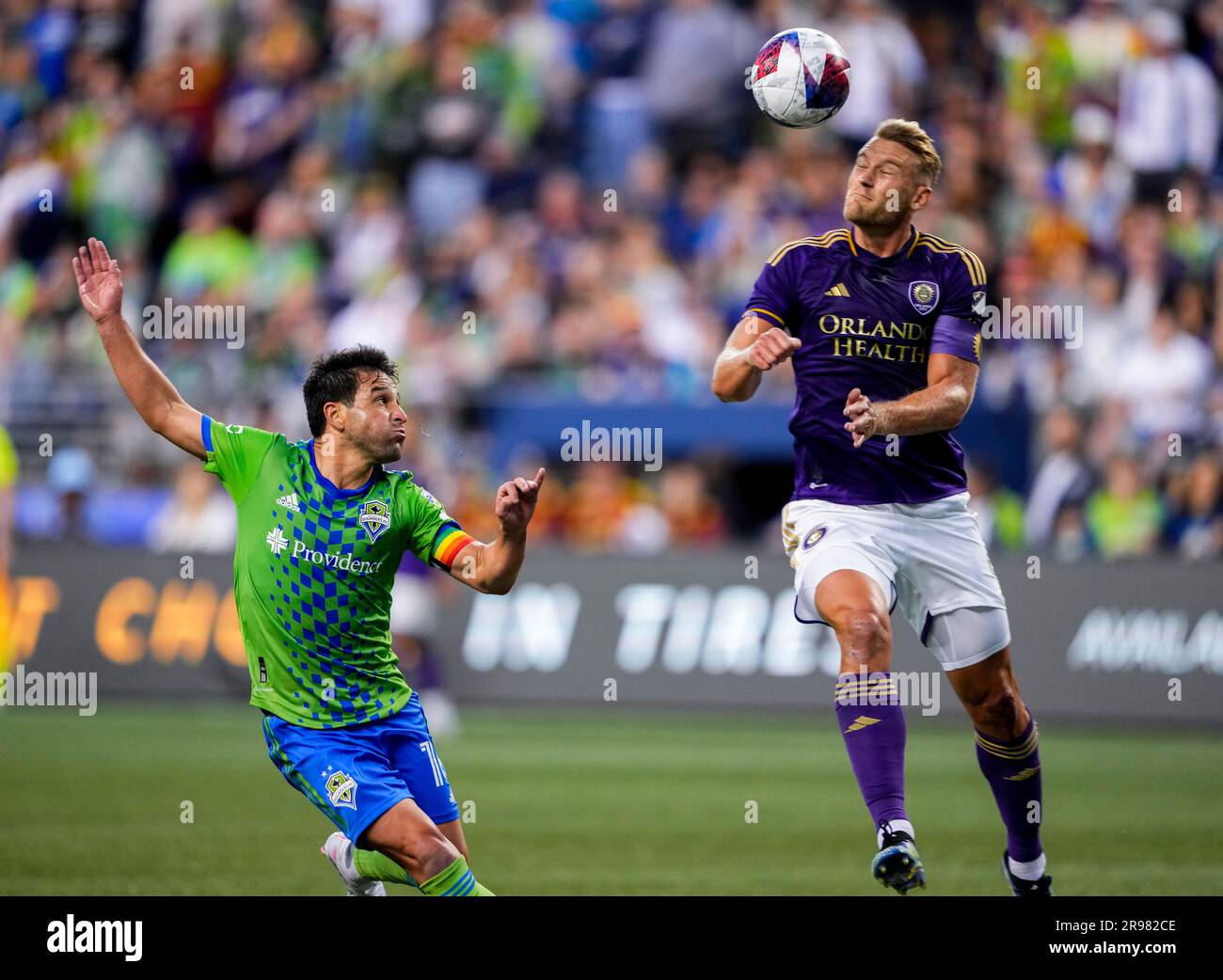 Orlando City defender Robin Jansson heads the ball away next to Seattle ...