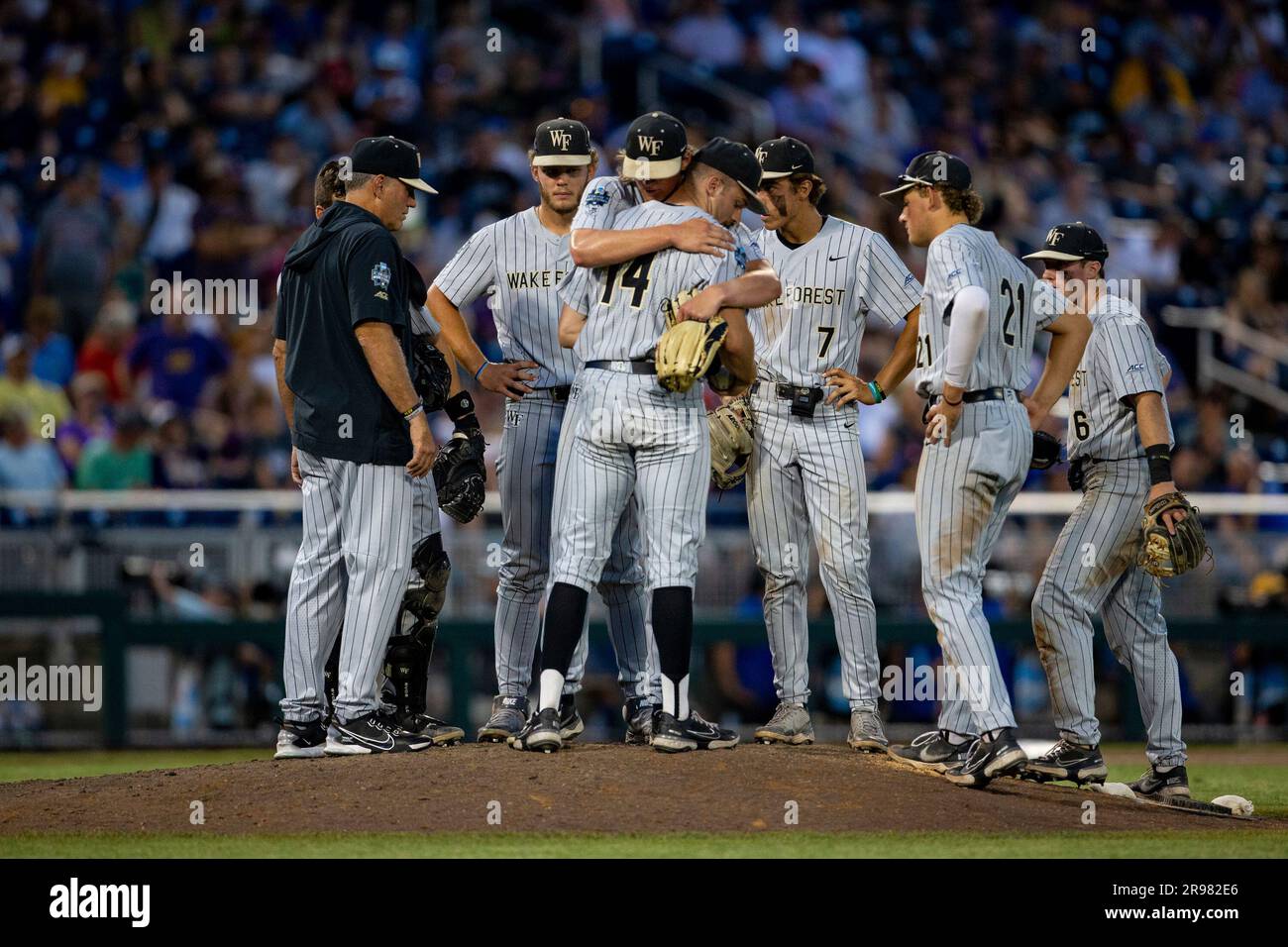 Wake Forest's Camden Minacci (14) gets a hug from Michael Massey in the ...