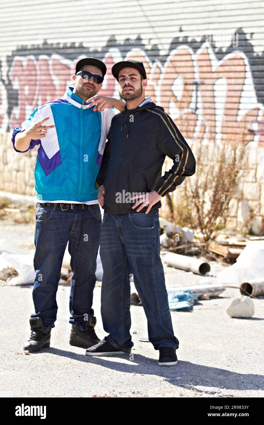 Graffiti artist, city and portrait of men in street stand by art ...