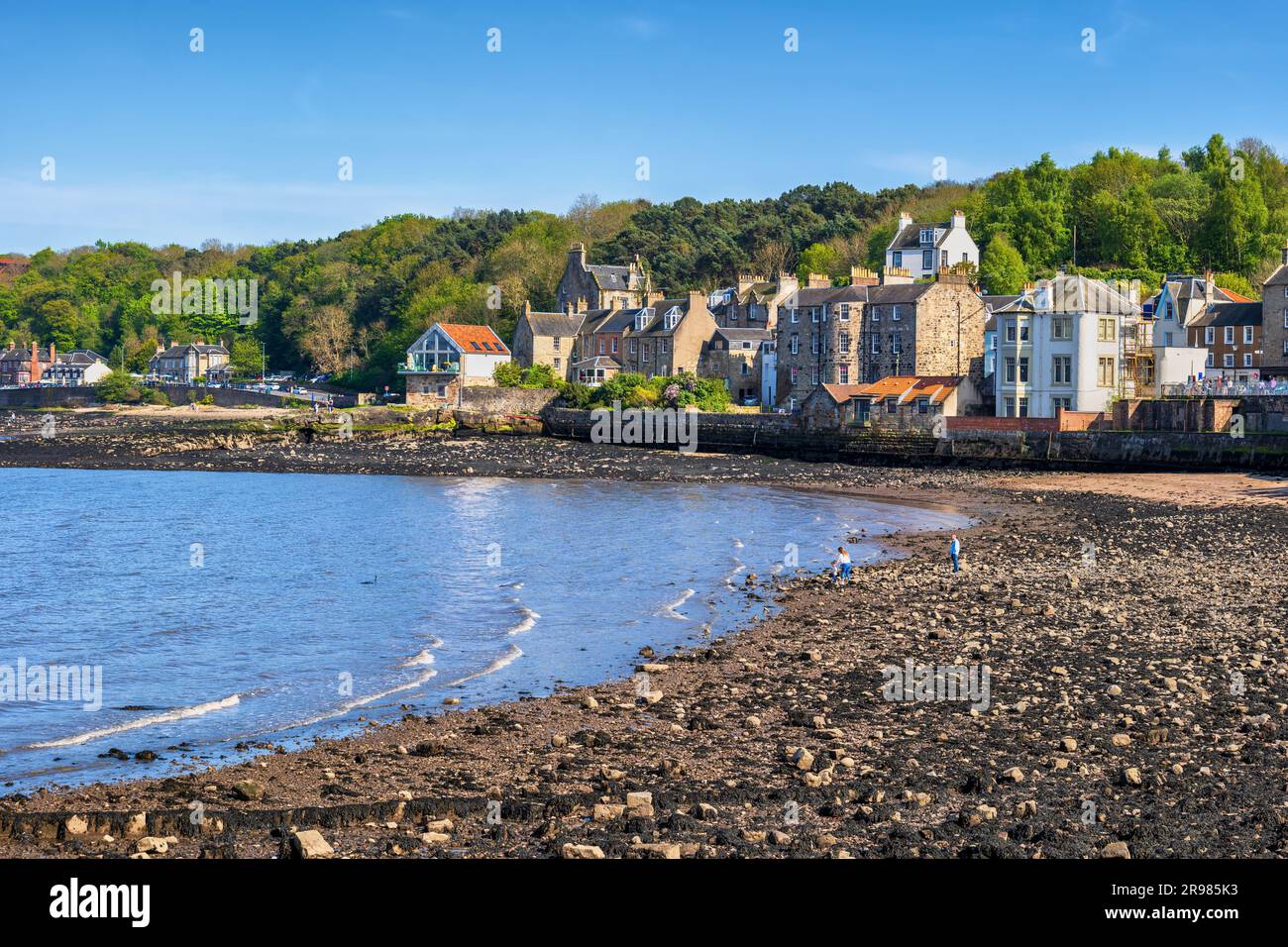 South Queensferry town skyline from shore of Firth of Forth estuary ...