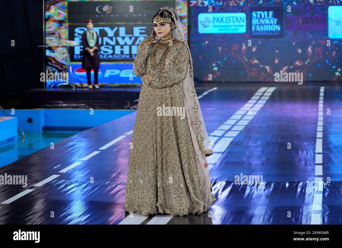 A model presents creations by My Apparels during a Fashion Show in Karachi, Pakistan, Sunday ...