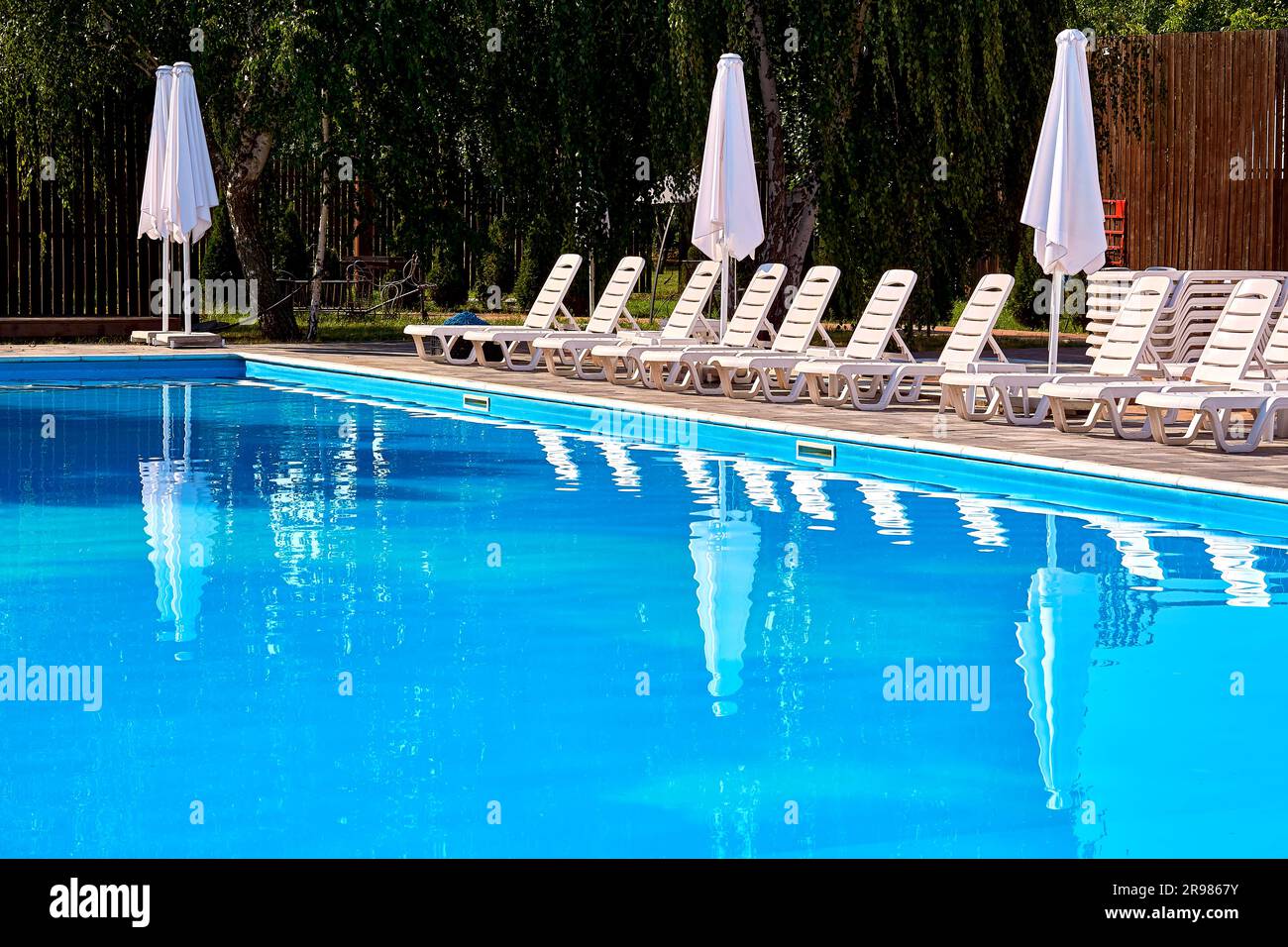 Summer outdoor pool at the resort with sun loungers waiting for people ...