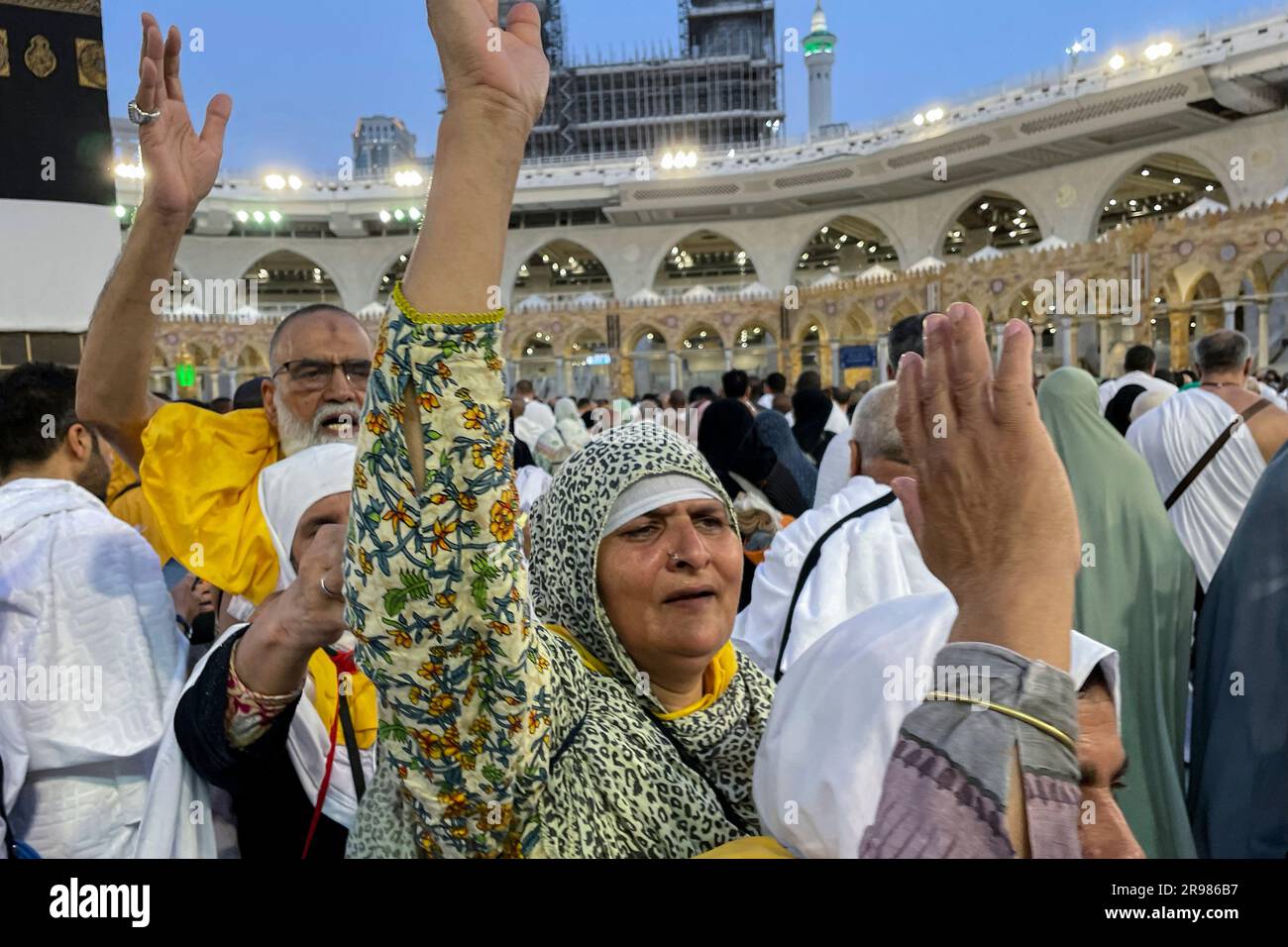 Iranian pilgrims circumambulate around the Kaaba, the cubic building at ...