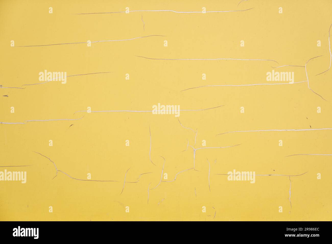 The texture of a cracked yellow surface as a close-up background with ...